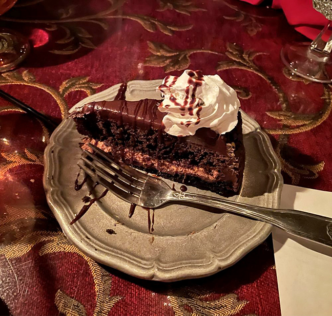 A slice of chocolate cake so decadent it should come with its own warning label. That whipped cream and drizzle are just showing off now.