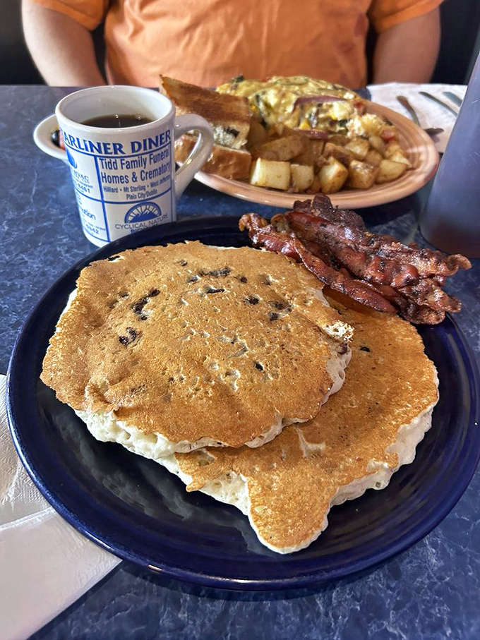 Pancakes that look like they were made by someone who truly understands joy. Add bacon, and you've got breakfast nirvana on a blue plate.