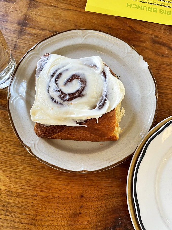 This cinnamon roll isn't playing games. That cream cheese frosting is making promises that the pillowy dough fully intends to keep.