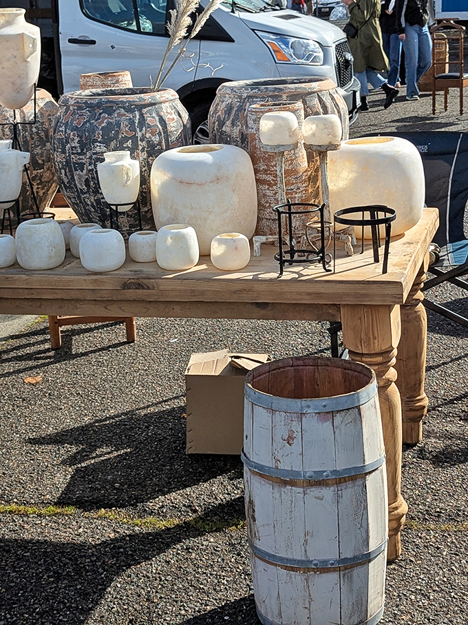 Ceramic vessels in earthy tones create a minimalist's dream display. That weathered barrel probably wasn't originally intended as a statement piece, but here we are.