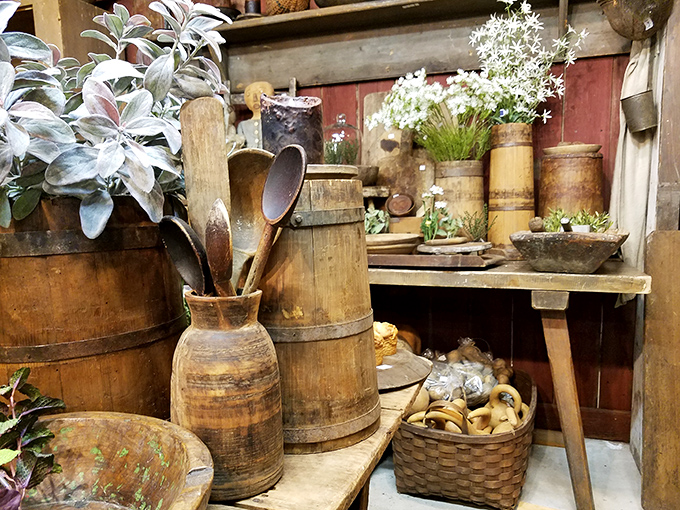 Rustic wooden containers and vintage utensils create a farmhouse fantasy. Martha Stewart would clear her schedule for this display.