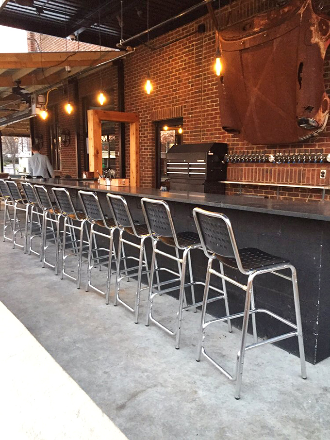 The outdoor bar invites lingering conversations as Edison bulbs stand ready to illuminate evening gatherings when Georgia's heat finally relents.