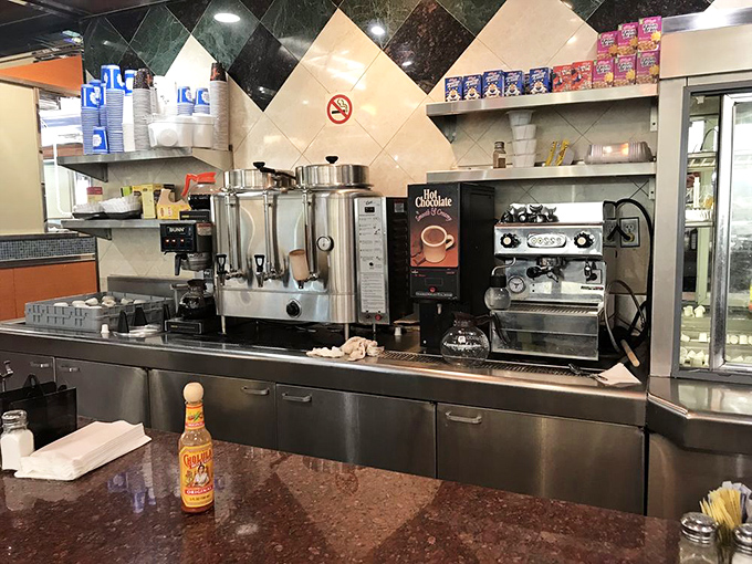 The coffee station stands ready like mission control for breakfast operations, where the elixir of morning motivation flows continuously.