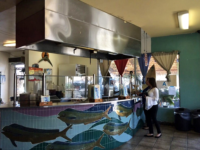 The counter where magic happens, complete with swimming fish tiles that seem to be heading straight for the fryer. They know what's good.