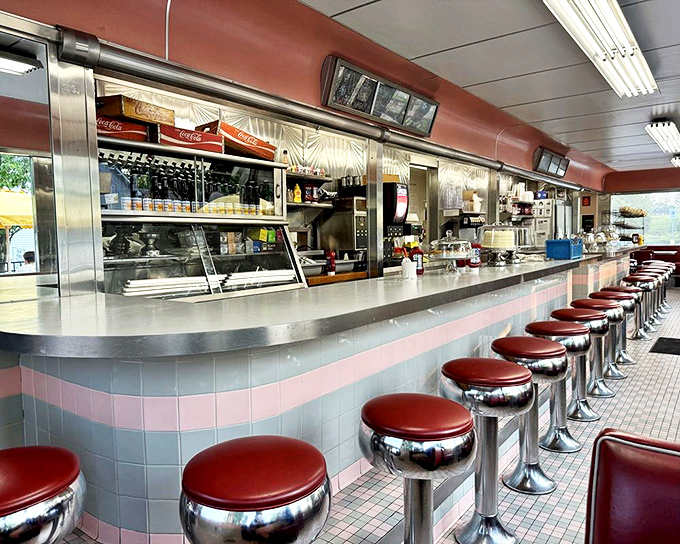 The parade of red-topped stools stands ready, each one a front-row seat to the choreographed ballet of short-order cooking and coffee pouring.
