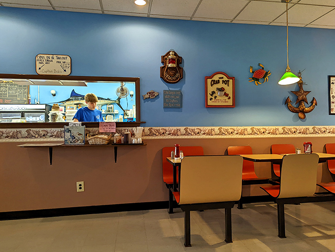The order counter where seafood dreams come true. That blue-walled, nautical-themed backdrop sets the stage for the ocean-to-table performance about to unfold.