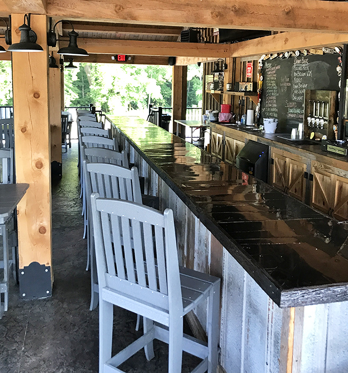 The outdoor bar beckons with its row of inviting stools, promising cold drinks and the kind of conversations that solve the world's problems.