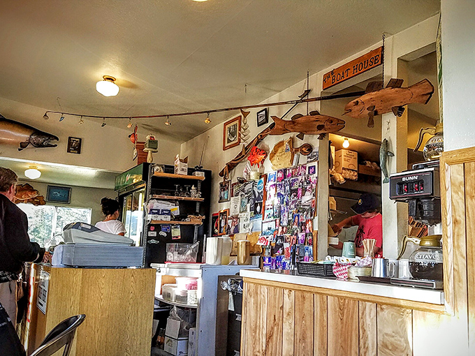 The ordering counter – where dreams of perfectly fried seafood begin. Note the wall of memories and wooden fish keeping watch overhead.