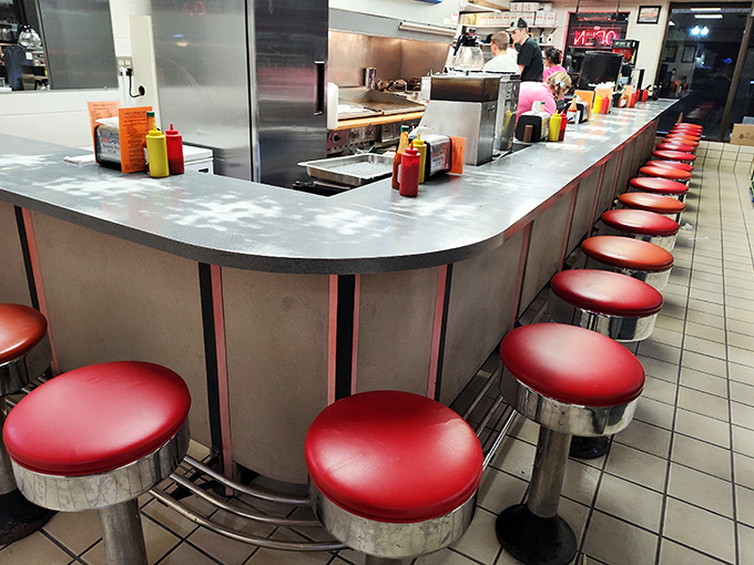 The L-shaped counter creates the perfect theater-in-the-round where burger drama unfolds daily to satisfied audiences.