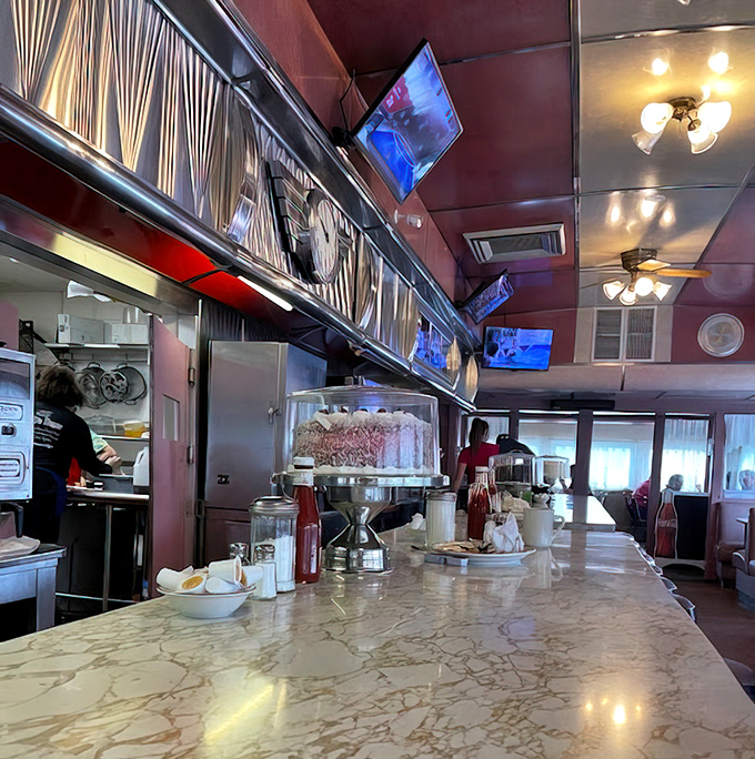 The marble counter gleams under classic lighting fixtures &ndash; a stage where breakfast dreams come true one plate at a time.