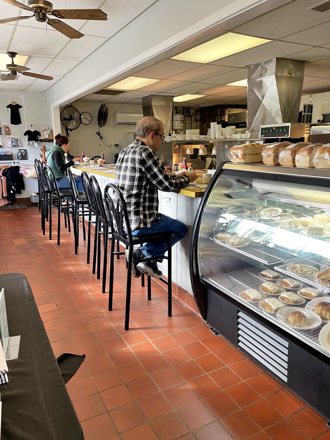 The counter seating offers front-row tickets to the culinary show, where regulars exchange local gossip and newcomers become instant friends.