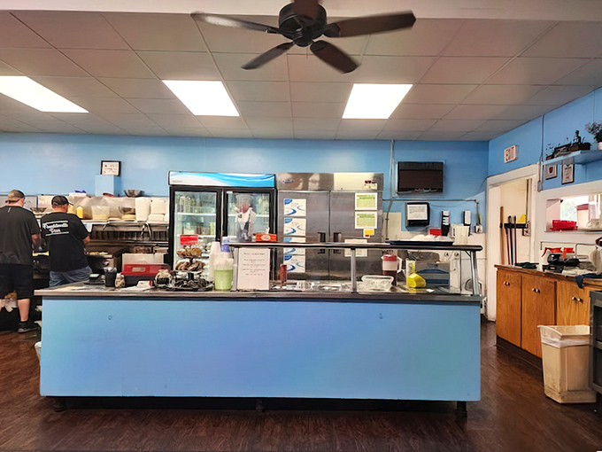 The command center – a blue-trimmed counter where orders are called, coffee is poured, and the rhythm of diner life plays out like a well-rehearsed symphony.