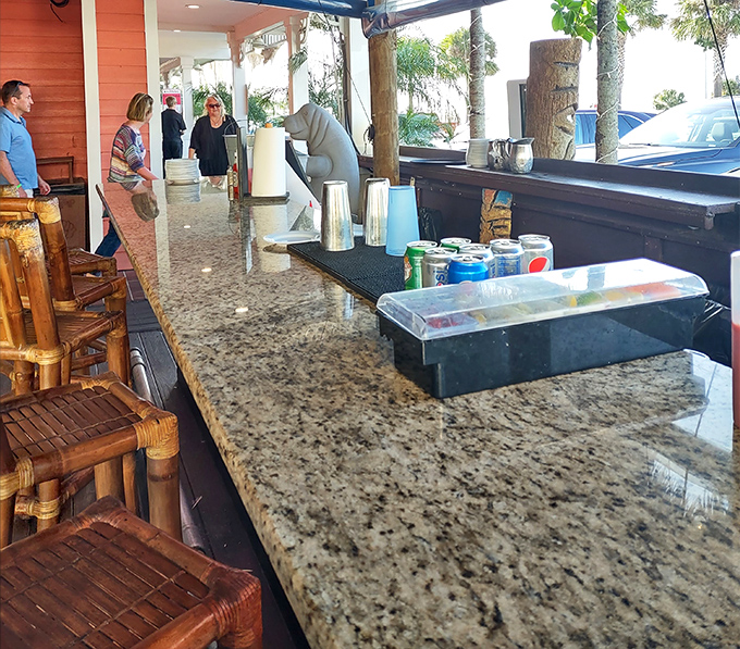 The outdoor bar where granite meets bamboo, and where waiting for a table becomes its own mini-vacation with ocean breezes included.