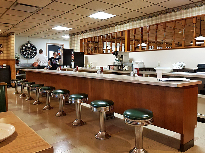 The counter where solo diners find community, where coffee refills flow freely, and where the pie case tempts you with sweet possibilities.