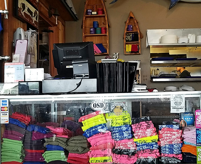 Colorful t-shirts stacked like a rainbow behind the counter&mdash;because the best souvenirs are the ones that make friends back home jealous.