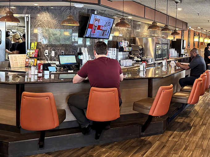 The counter &ndash; where solo diners become temporary family, watching the rhythmic ballet of short-order cooking while perched on coral-colored thrones.