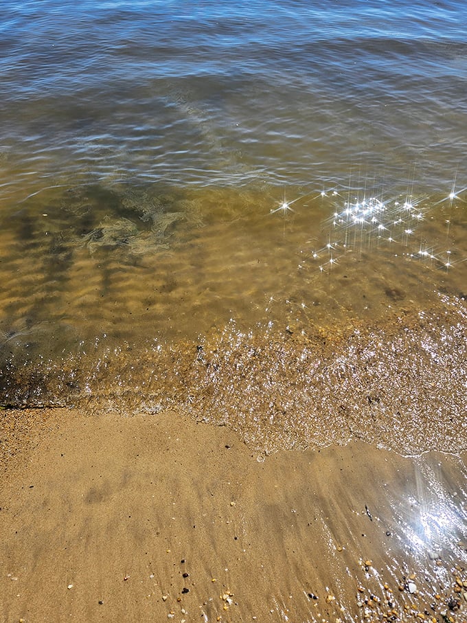 Crystal clear shallows where each ripple writes temporary messages on the sandy canvas below.