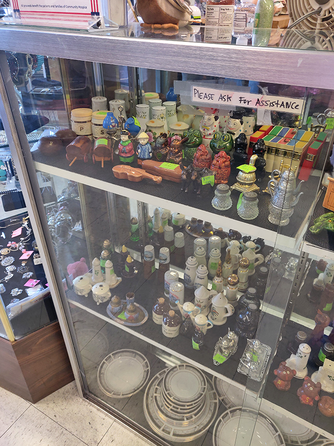 A cabinet of curiosities where salt-and-pepper shakers and figurines stand at attention, waiting for their next windowsill assignment.