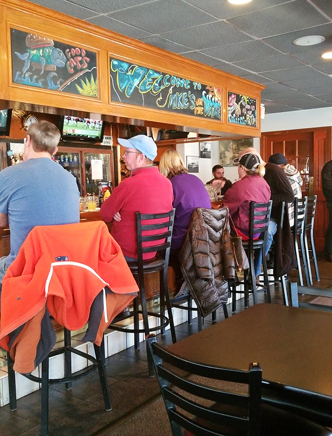 "Welcome to Jake's" glows above patrons who've clearly discovered what you're about to learn—this is where Avon Lakers come when they're serious about dinner.