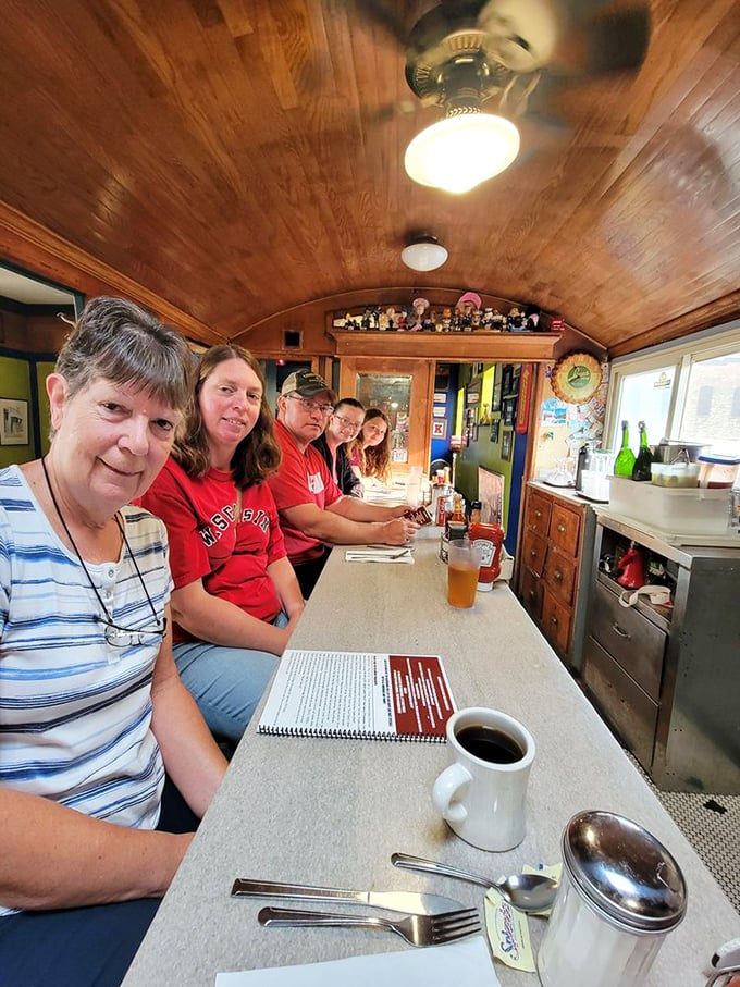 Happy diners sharing stories and smiles in the warm glow of genuine hospitality and exceptional comfort food.