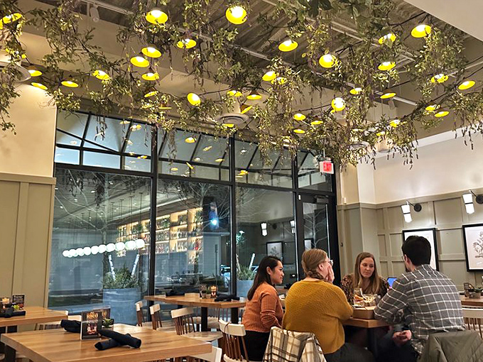 Even the ceiling gets special treatment with cascading greenery and yellow lights creating an atmosphere that says, "Yes, you should definitely order dessert."