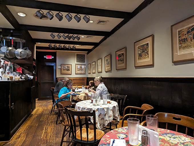 Diners settle into comfortable conversations while framed artwork watches over meals that create lasting memories and satisfied smiles.