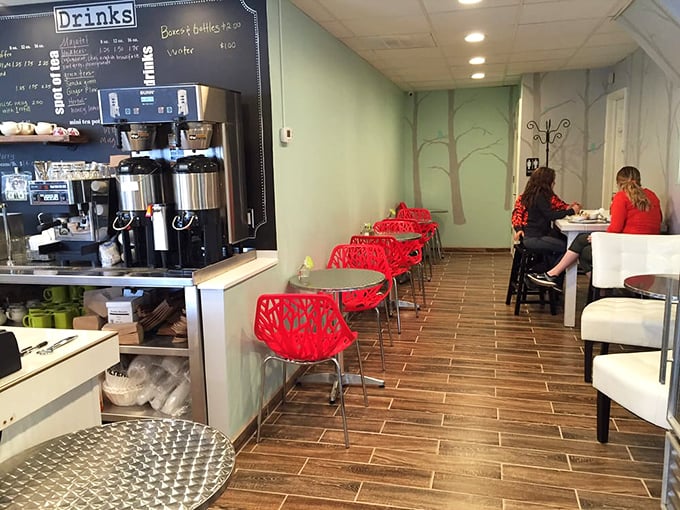 Modern meets cozy with those striking red chairs against mint walls. The painted trees remind you that good things grow from simple ingredients.