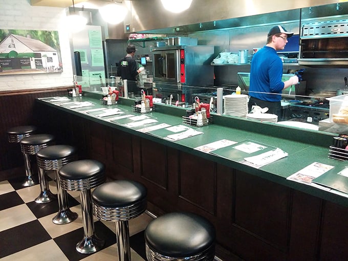 Classic diner counter seating &ndash; where solo diners become temporary neighbors and the kitchen's symphony plays just feet away.