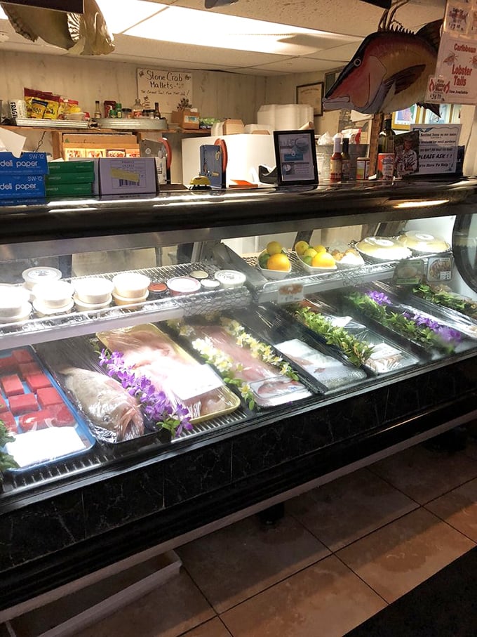 The display case showcases today's fresh catches, adorned with edible flowers. This isn't just seafood&mdash;it's seafood that dressed up for the occasion.