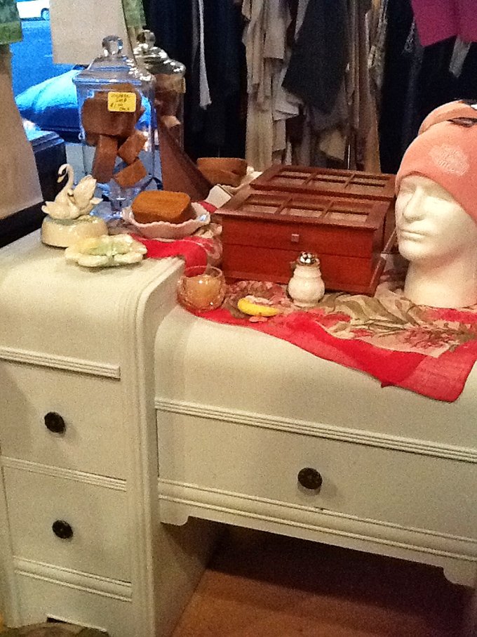 Pristine white vanity dresser staged with vintage treasures creates a vignette worthy of an interior design magazine, all at thrift store prices.