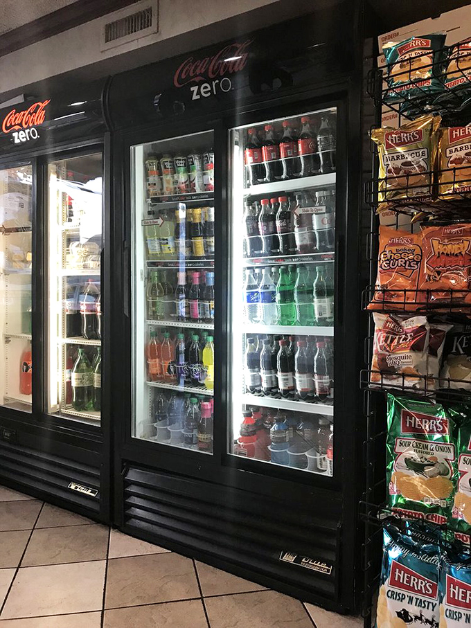 The drink coolers stand ready like soldiers, prepared to complement your meal with the perfect carbonated companion.