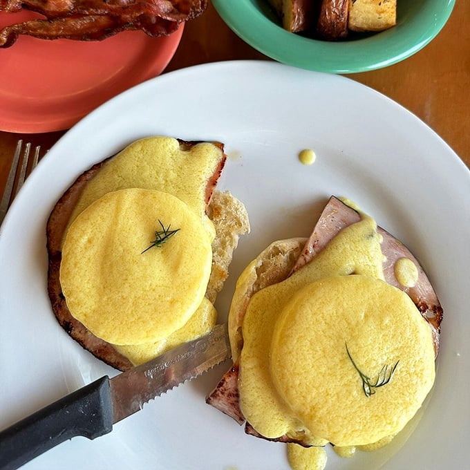 Eggs Benedict executed with textbook precision. The hollandaise drapes over those English muffins like a silky yellow blanket of happiness.