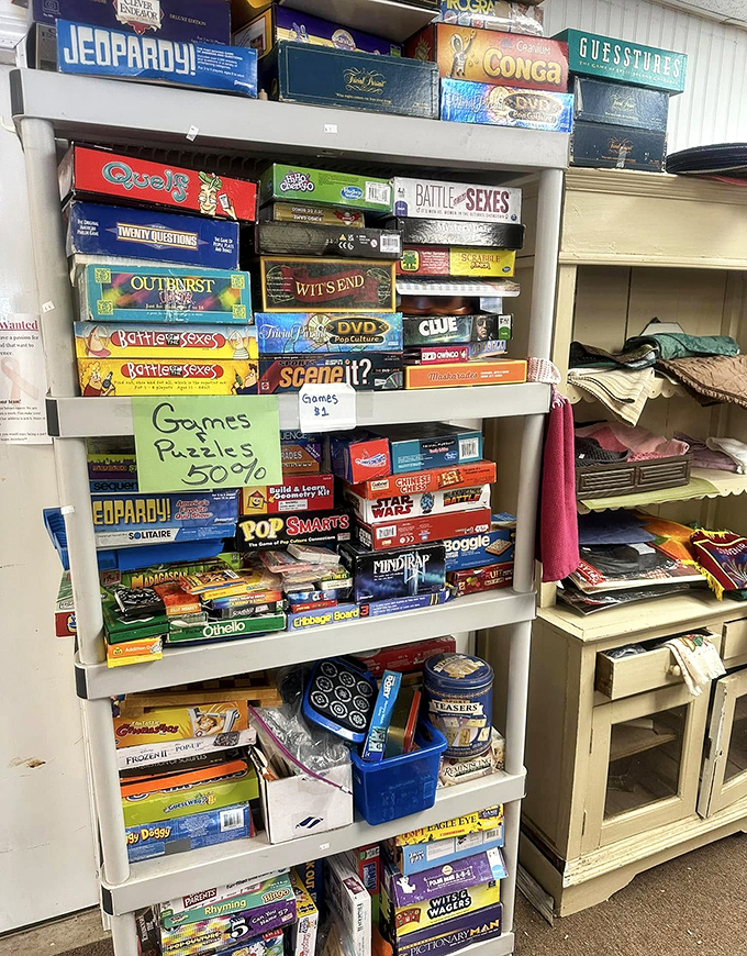 Board games stacked like a timeline of family game nights past. Half-priced entertainment that doesn't require charging or software updates.