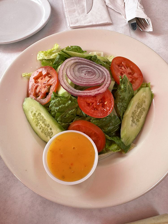 Even the garden salad shows respect for simplicity: crisp greens, ripe tomatoes, cucumber, and red onion with house-made dressing.