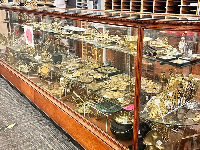 All that glitters actually is gold in this display case. Brass treasures shine like buried pirate booty under the fluorescent lights.