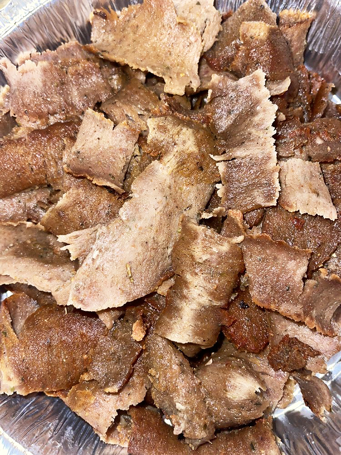 Thinly sliced gyro meat that's been spinning its way to perfection. Each piece tells a story of spices and slow cooking.
