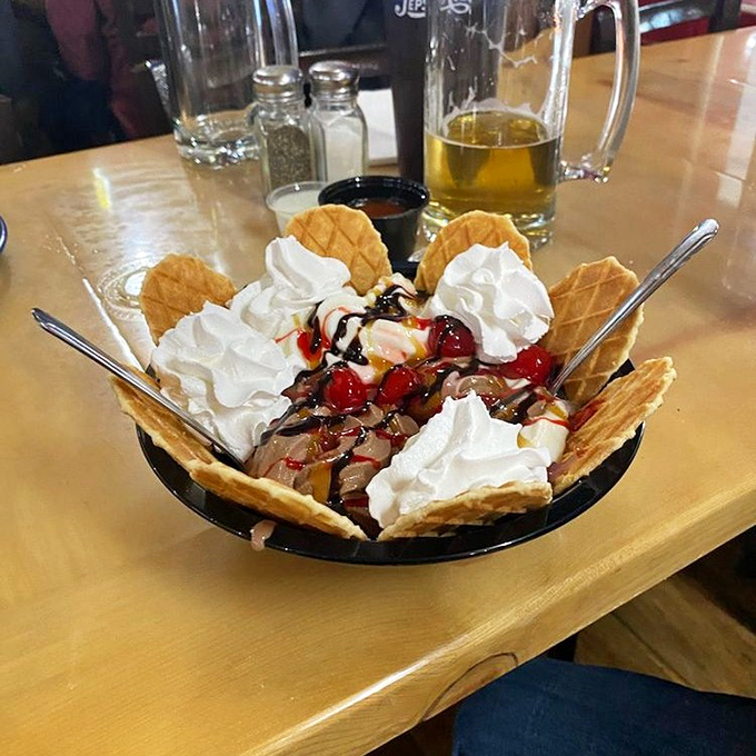 Ice cream sundae that's not messing around. Waffle cookies stand at attention around whipped cream mountains and cherry-topped valleys of sweet satisfaction.
