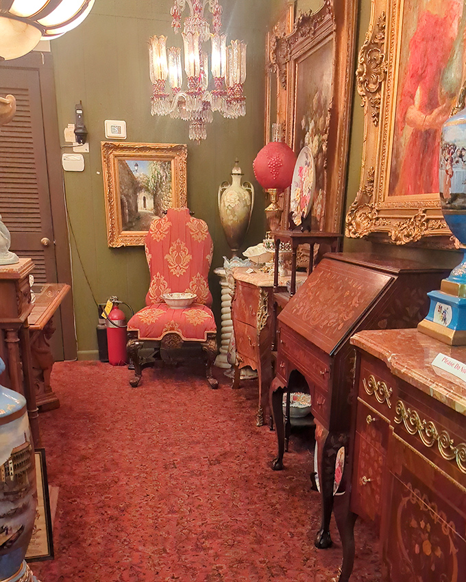 That red upholstered throne-like chair isn't just seating – it's a statement that says "Yes, I do consider myself antique royalty, thank you."