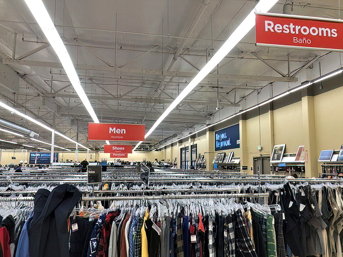 Clear signage guides your thrifting expedition. The men's section beckons with promises of hidden gems and forgotten styles.