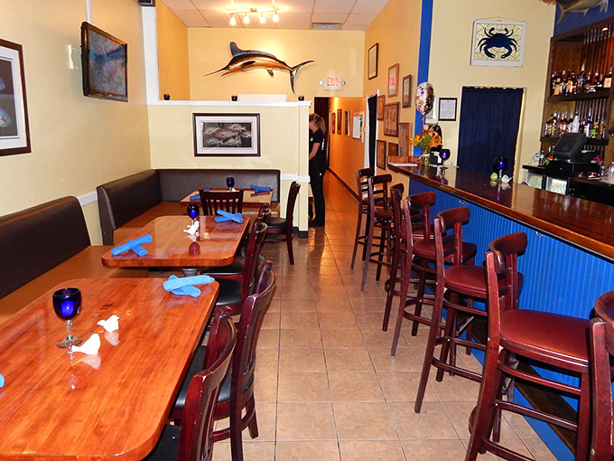 Blue napkins pop against wooden tables in this cozy dining room where seafood stories are shared and created.