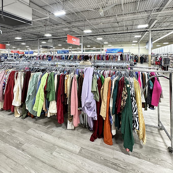 The kids' section bursts with color like a rainbow after a storm. Outgrown but not unloved, these clothes await their second childhood.