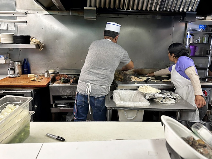 Behind those turquoise walls, skilled hands work their daily magic, turning simple ingredients into culinary gold. 