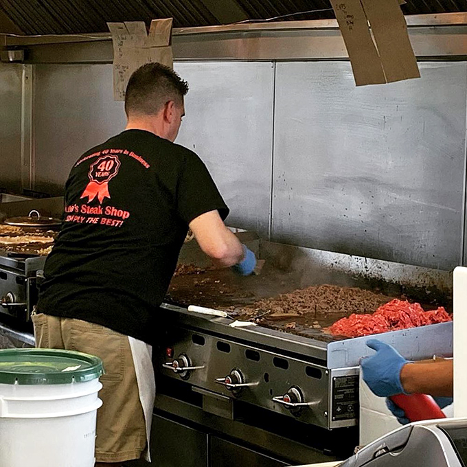 The sacred flat-top grill where the magic happens. Notice the practiced hand of someone who's made thousands of these beauties.