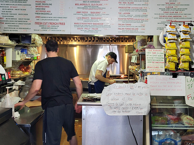 Behind the counter, sandwich artists work their magic with practiced efficiency &ndash; no wasted movements in this culinary choreography.