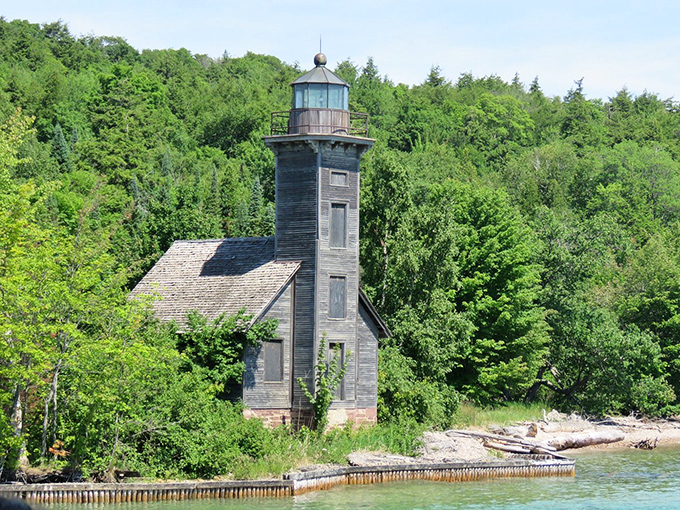 The East Channel Lighthouse stands as a weathered sentinel, its wooden frame telling silent stories of ships guided safely home through Superior's notorious fog.
