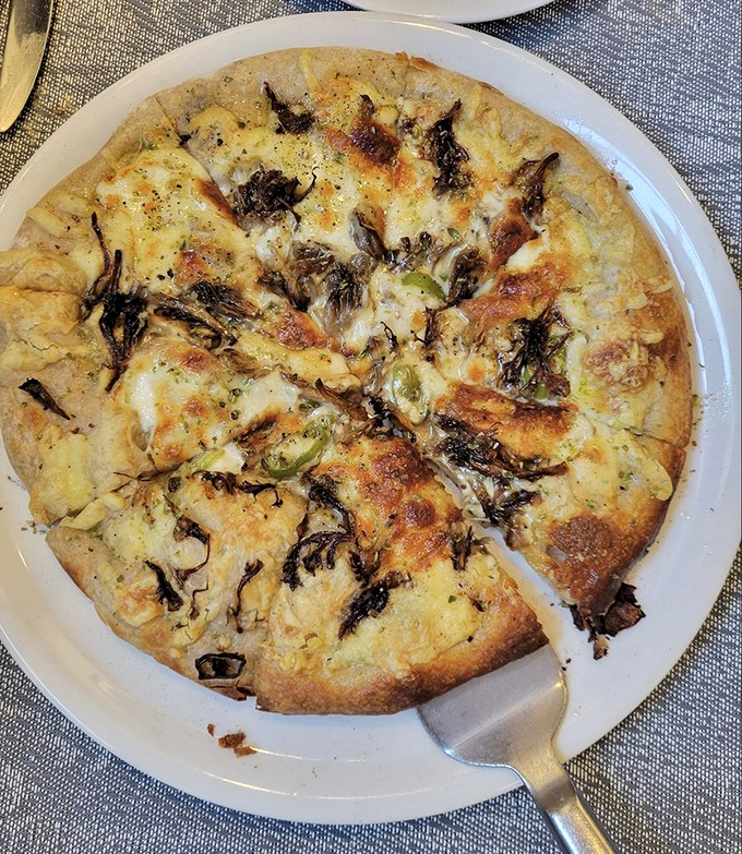 A pizza that proves simplicity is the ultimate sophistication. Those caramelized edges tell you everything you need to know about the care taken here.