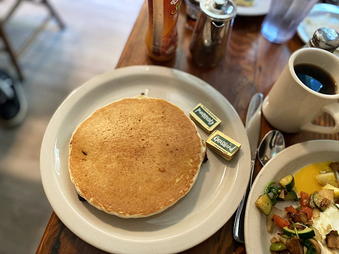 A pancake so perfectly golden it belongs in Fort Knox. Simple, unadorned, and ready for its maple syrup baptism.