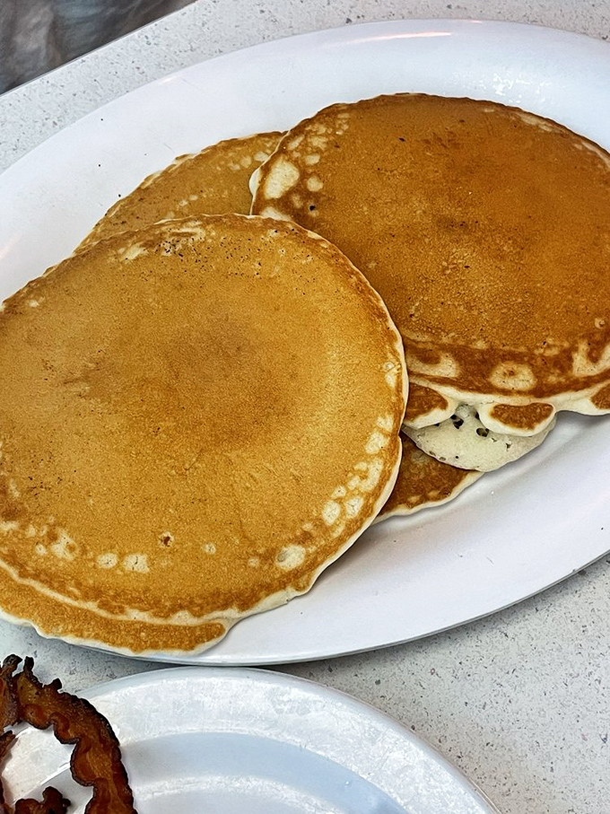Pancakes with the perfect tan lines&mdash;golden edges giving way to fluffy centers. The kind that make you slow down, savor, and question why brunch was ever invented.