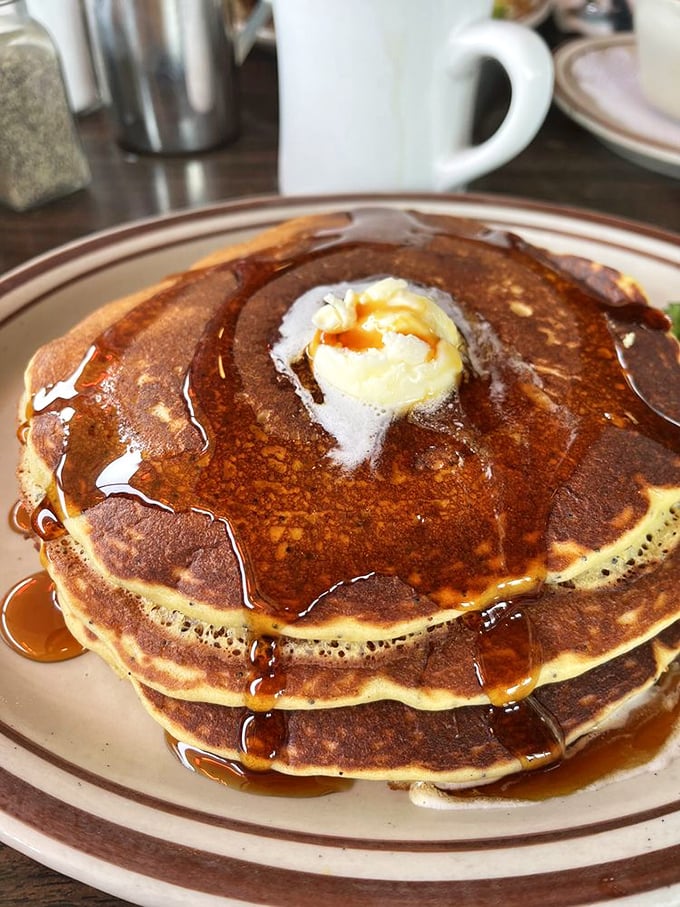 Pancakes stacked like golden discs of joy. That melting butter crater in the center is basically breakfast's version of reaching nirvana.
