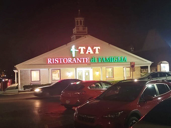 As night falls, the illuminated sign serves as a beacon of culinary comfort, drawing hungry pilgrims to this temple of traditional Italian-American cuisine.